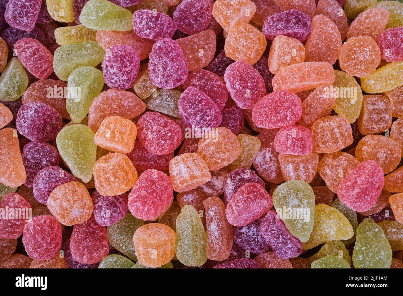 Full frame background of many multicolored gumdrops covered with sugar ...