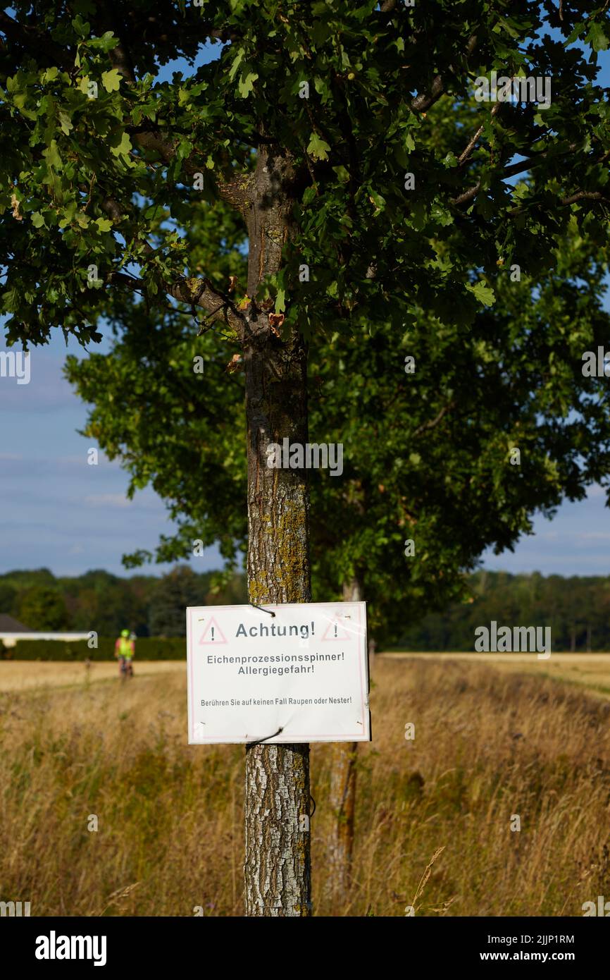 Warning sign in german letters showing to be causious because of oak ...