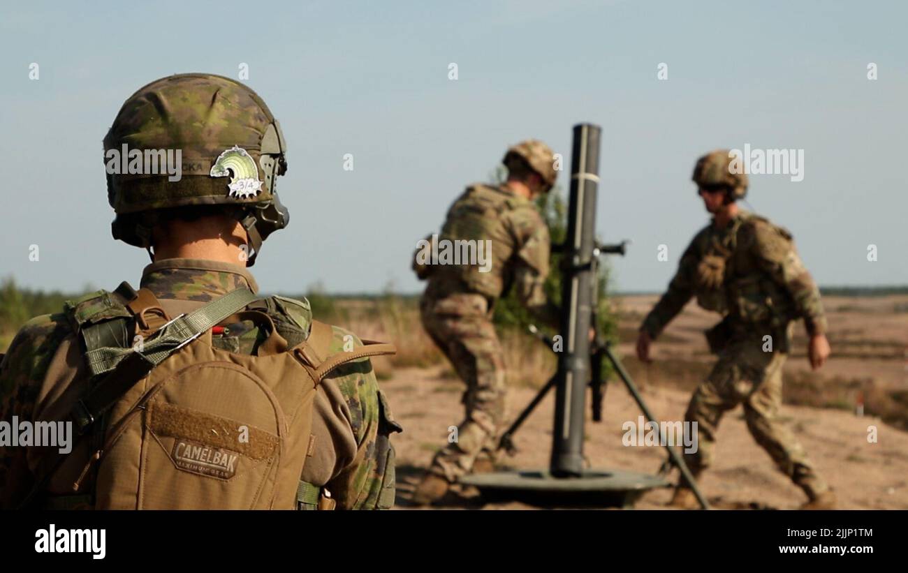 A Finnish soldier assigned to the Pori Brigade observes U.S. Soldiers ...