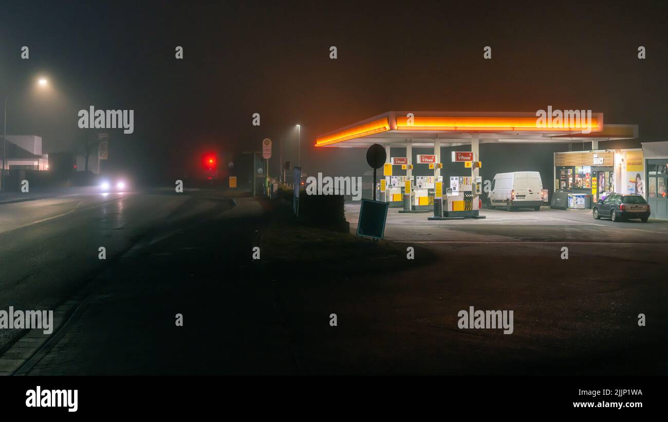 An illuminated Shell gas station in a dark and foggy night Stock Photo ...