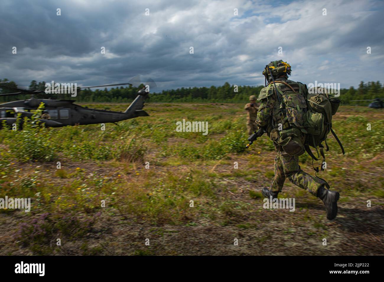 A Finnish soldier with the Satakunta Jaeger Battalion runs towards a UH ...