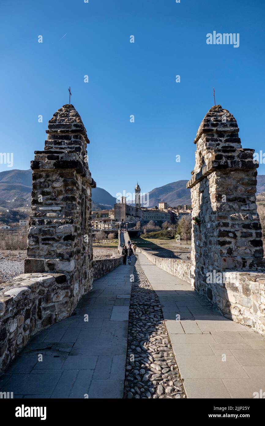 A vertical shot of the Ponte Gobbo (Hunchback Bridge) in Bobbio, Italy ...