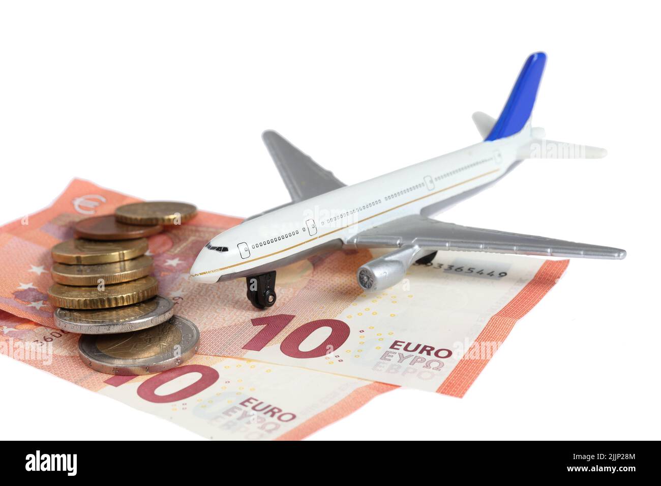 A plane toy on euro banknotes isolated on a white background - save ...