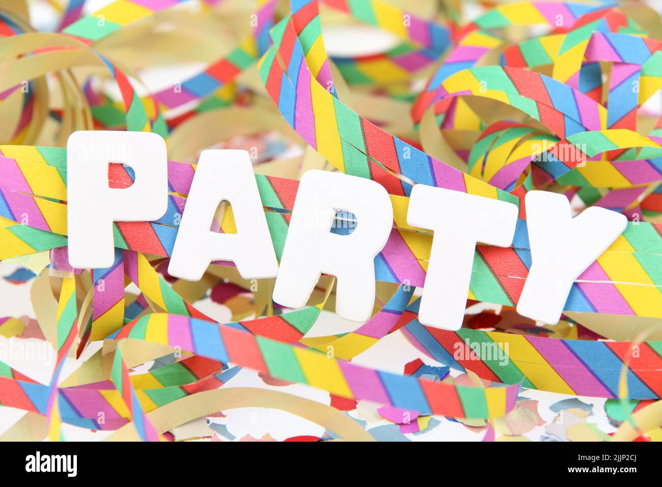The word party on colorful streamers and confetti isolated on a white ...