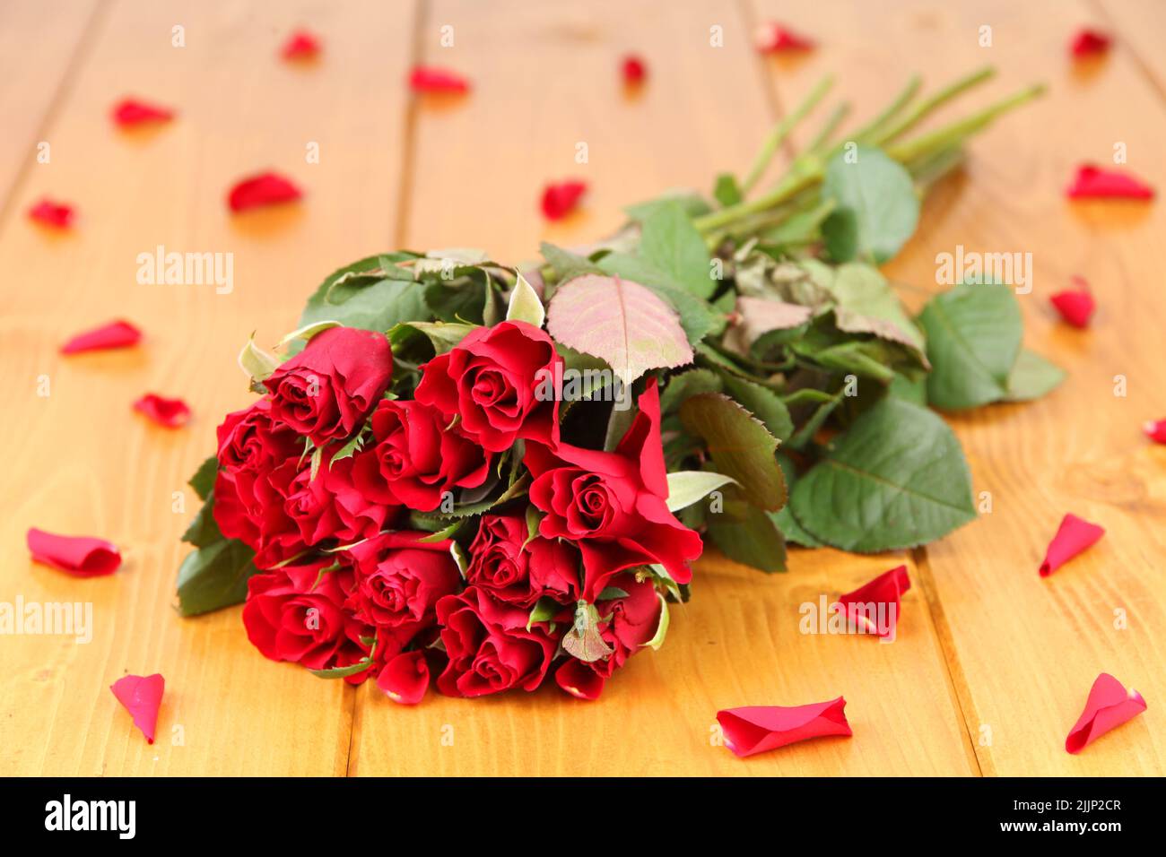 A beautiful bouquet of red roses on a wooden laminated floor Stock ...
