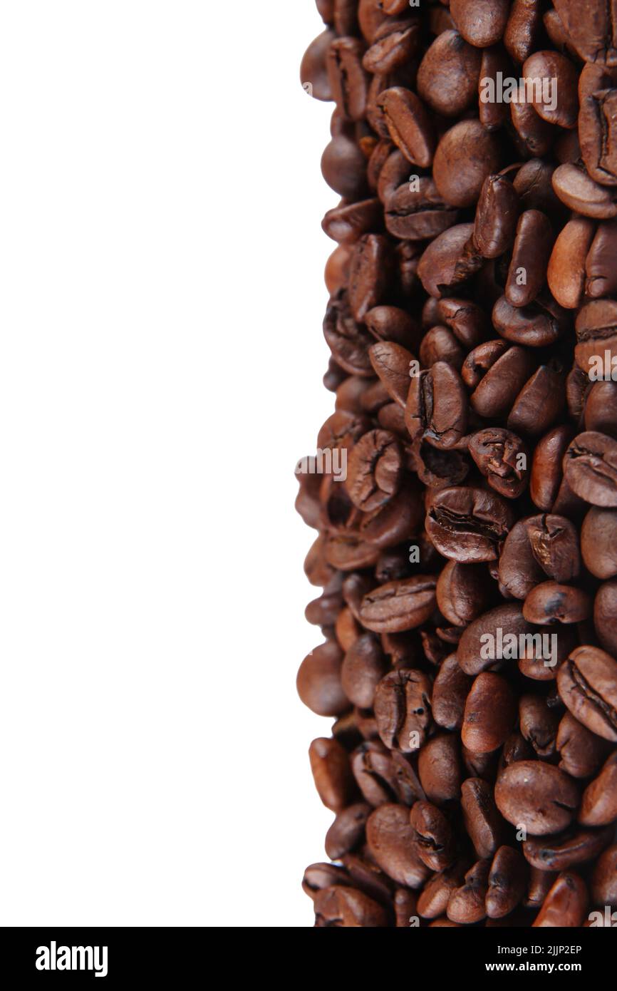 A vertical shot of coffee beans stripe isolated on white background ...