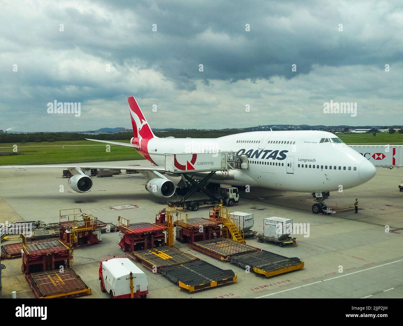 Quantas airplane on the tarmac at the airport under cloudy sky in ...