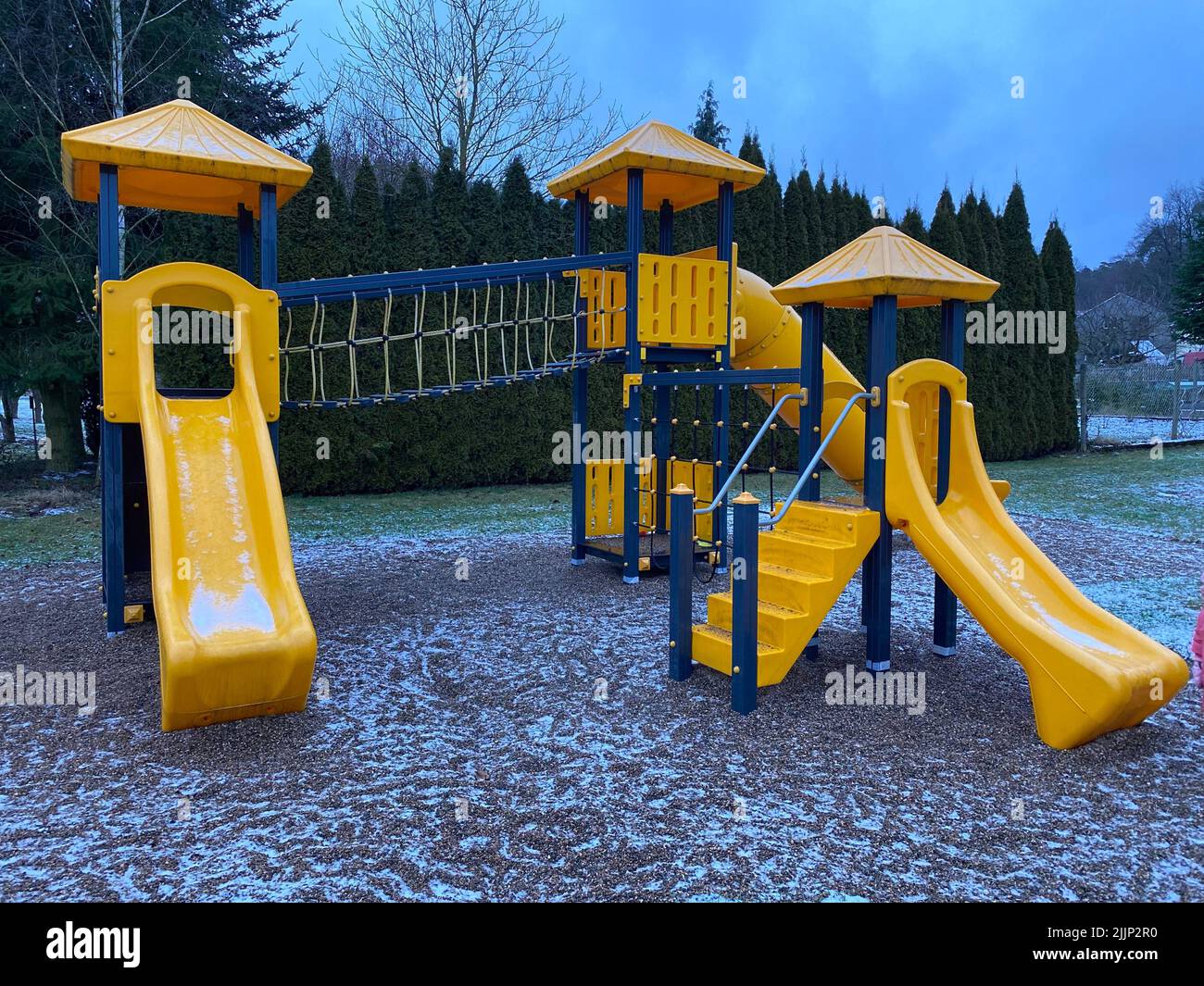 Yellow equipment in a playground in winter Stock Photo - Alamy