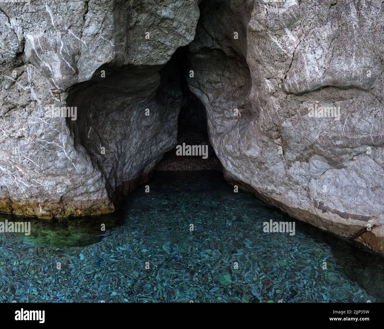 View of a small cave on Traganou beach Stock Photo - Alamy