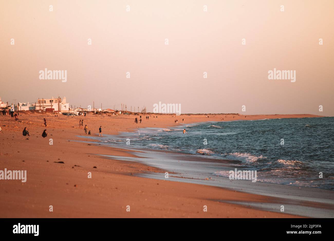 A beautiful view of the sandy shore, Praia de Faro, Portugal Stock ...