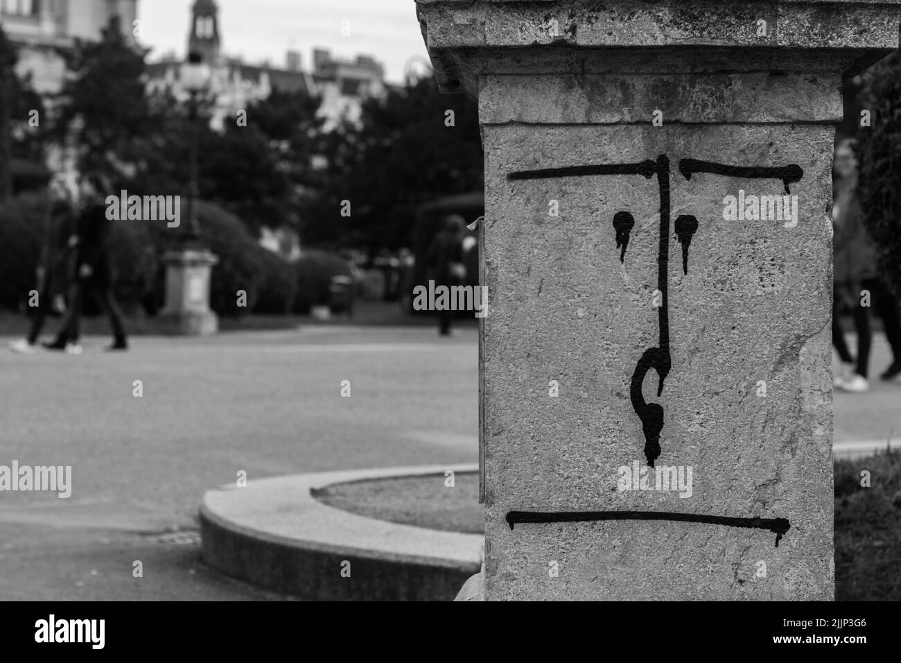 A grayscale shot of sad face graffiti on a wall Stock Photo - Alamy