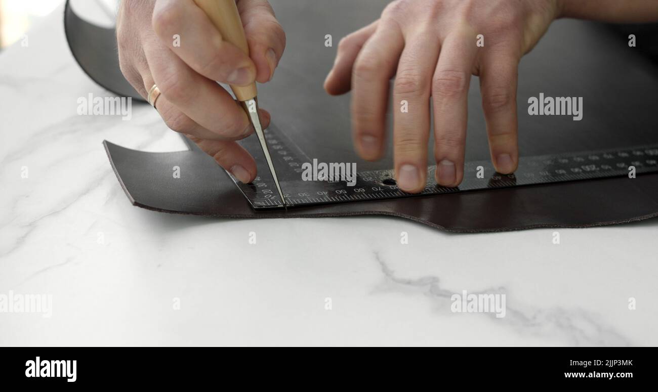 Working process of crafting a new handmade leather wallet in the ...