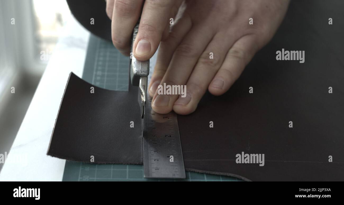 Working process of crafting a new handmade leather wallet in the ...