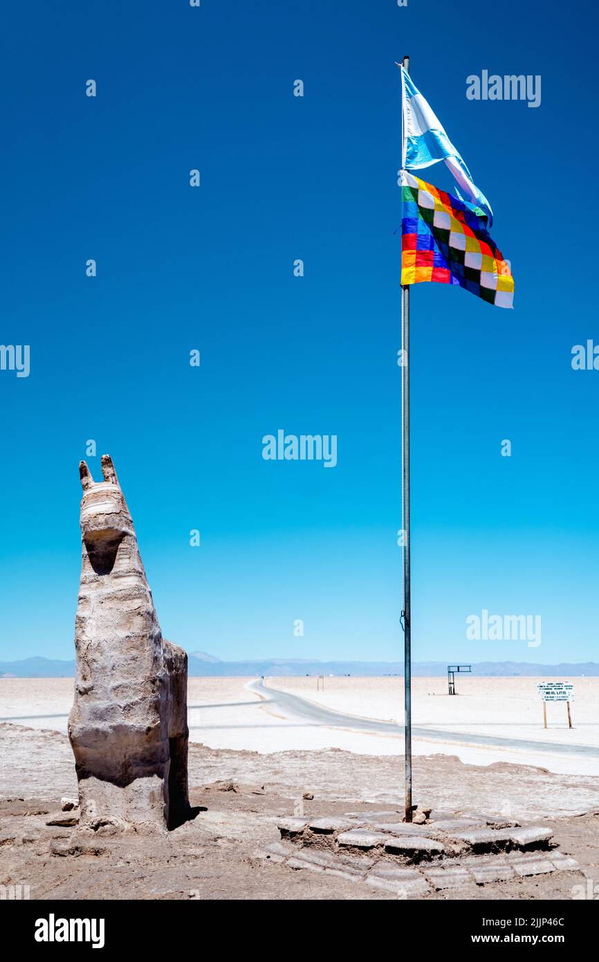 A beautiful view of a statue and flags in the Salinas Grandes ...
