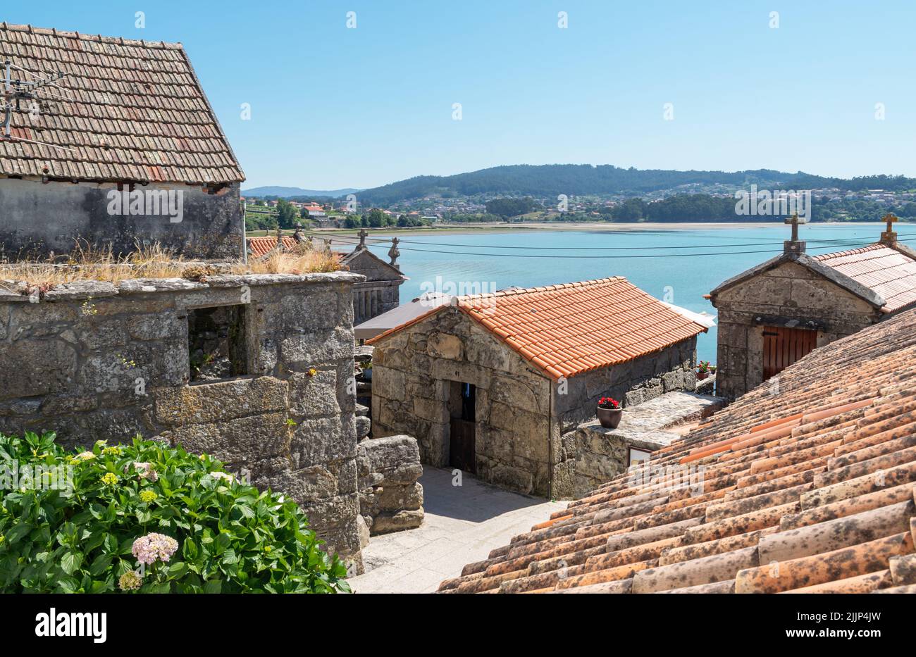 Old neighborhood with small stone buildings in the coastal Combarro ...