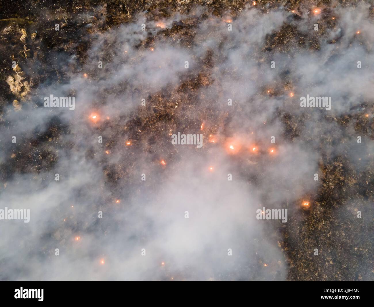 An overhead shot of a burning landfill site Stock Photo - Alamy