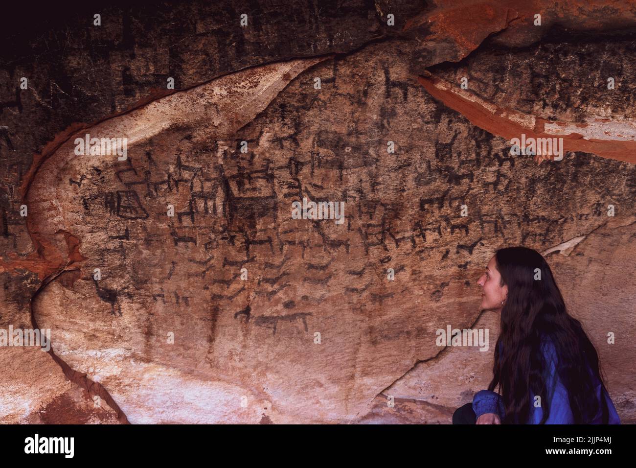 The portrait of a woman standing in the cave Stock Photo - Alamy