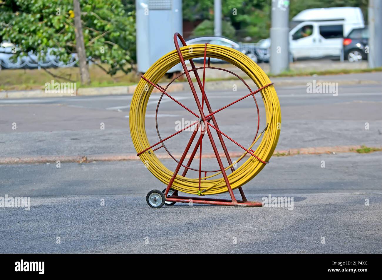 yellow metallic coil cart with optical cable for telecommunications ...