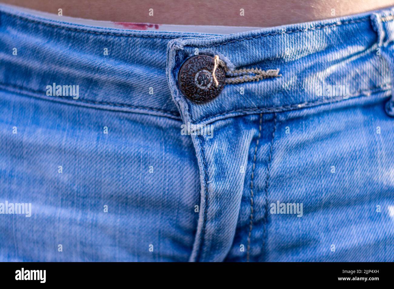 Denim material a piece of clothing fragment of the body Stock Photo - Alamy