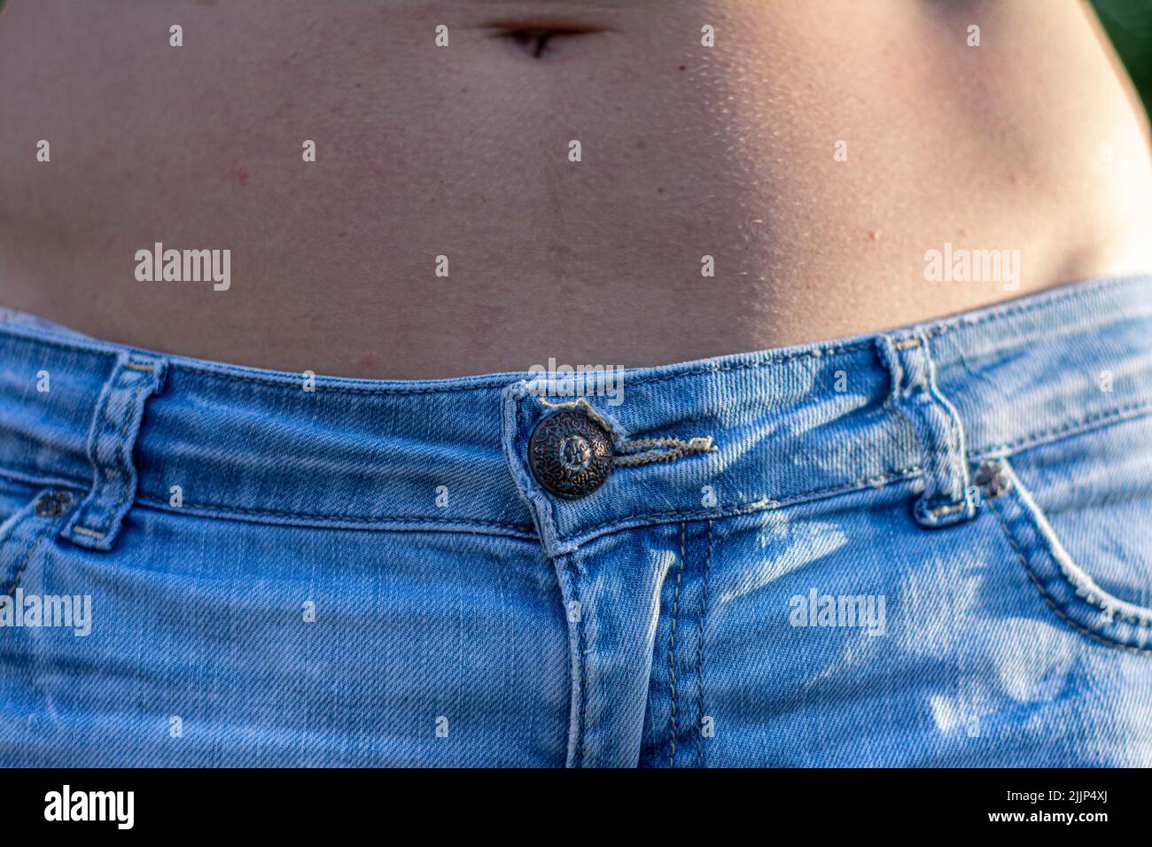 Denim material a piece of clothing fragment of the body Stock Photo - Alamy