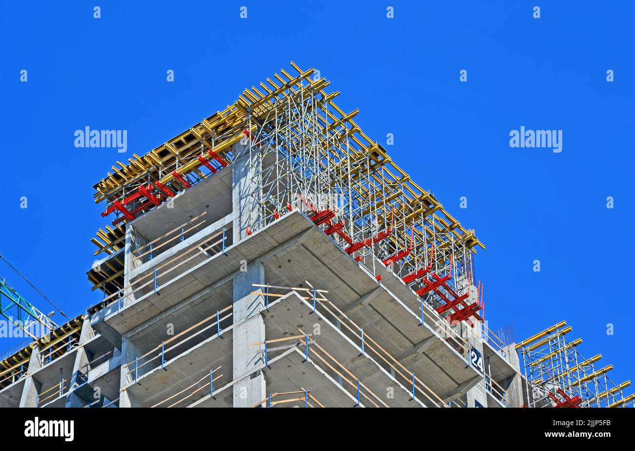 colorful scaffolding on azure sky in sunny day, modern building site ...
