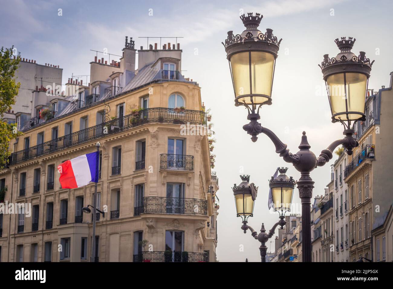 French flag winding and parisian architecture in Paris, France Stock ...