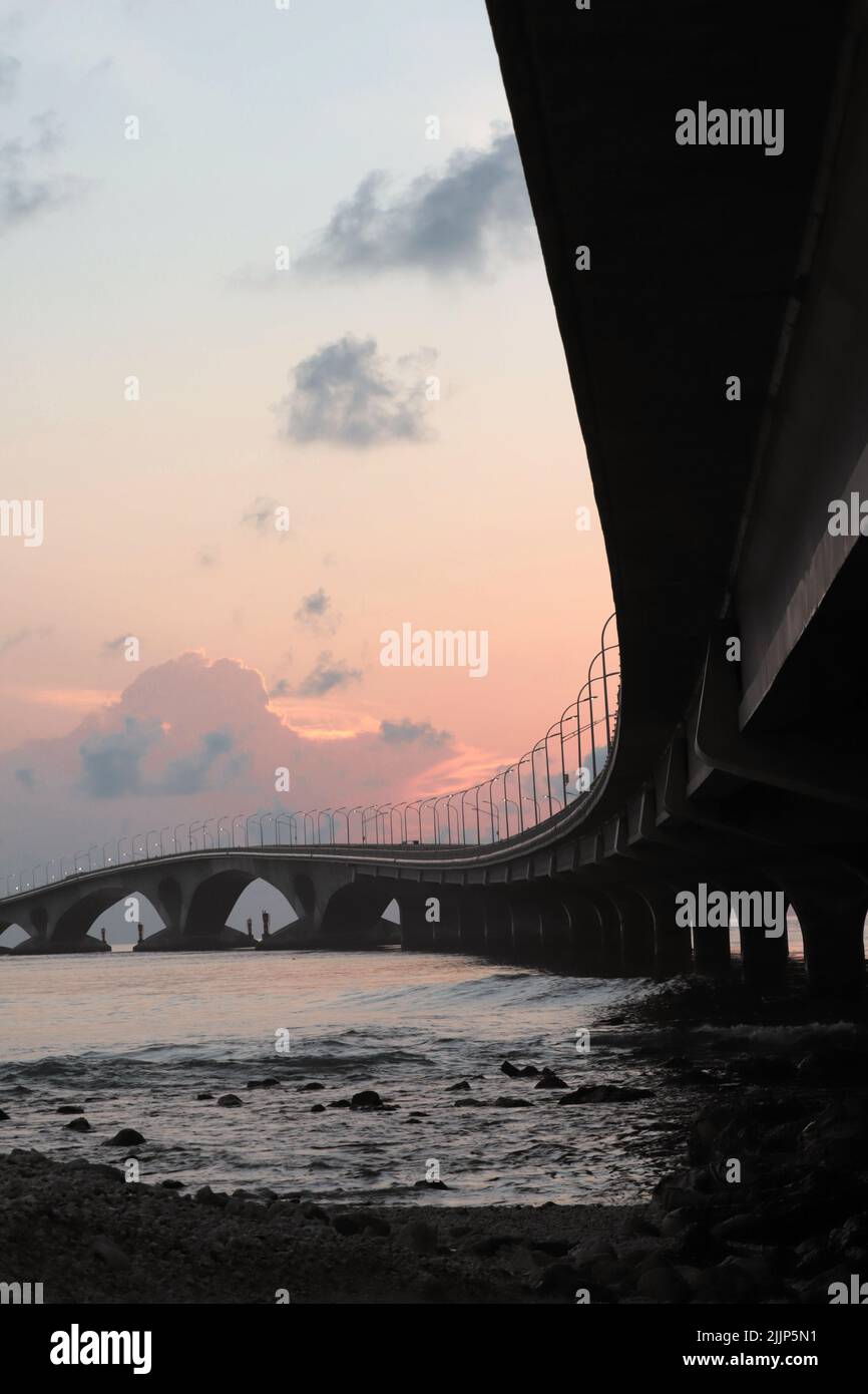 A vertical shot of the Sinamale Bridge during sunset in Maldives Stock ...