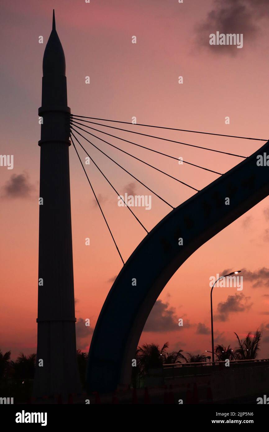 A vertical shot of the silhouette of pillar of the China-Maldives ...