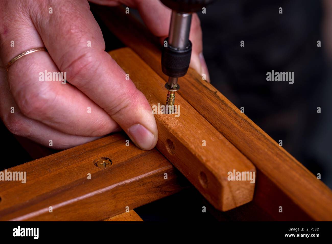 assembling the furniture with screwdriver. Cordless screwdriver or ...