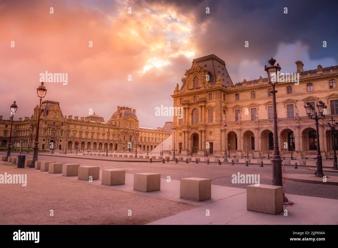 Louvre street lights from Tuileries and dramatic sky, Paris, France ...