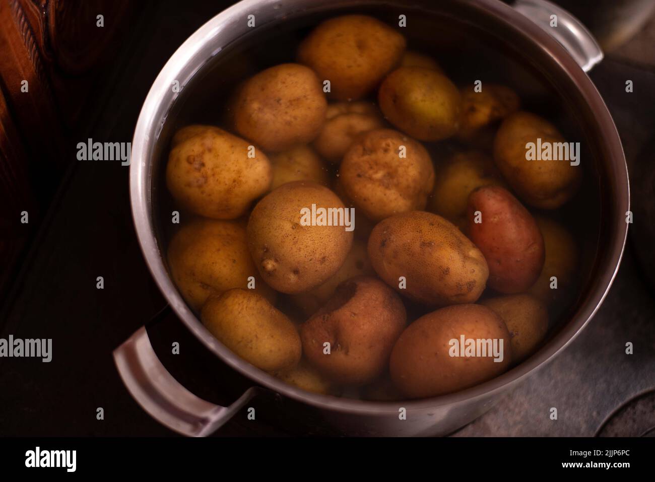 The potatoes boiling in a pot Stock Photo - Alamy