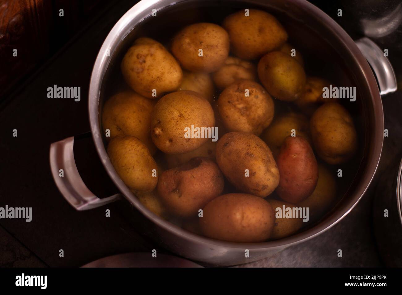 The potatoes boiling in a pot Stock Photo - Alamy
