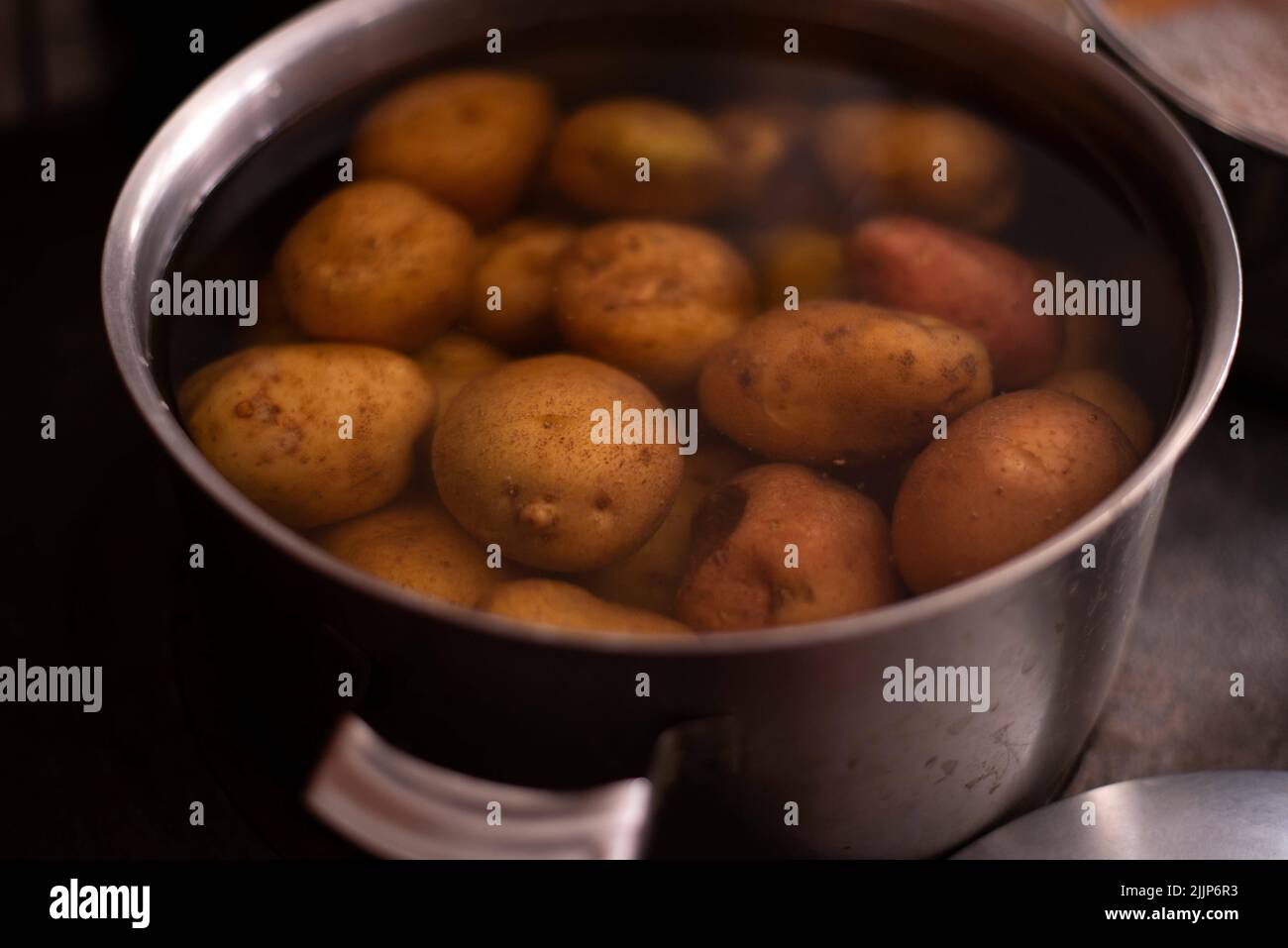 The potatoes boiling in a pot Stock Photo - Alamy