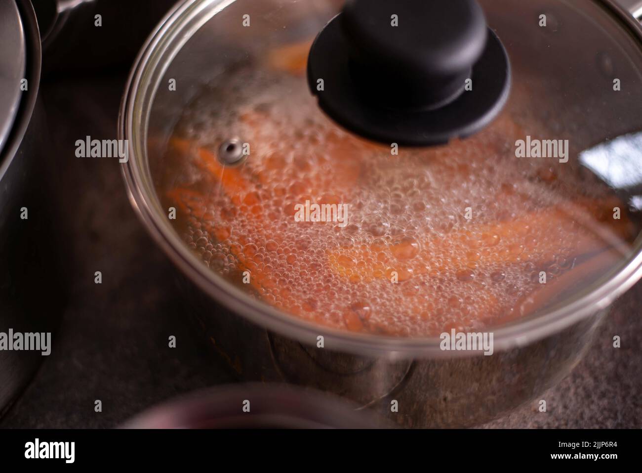 The carrots boiling in a pot Stock Photo - Alamy