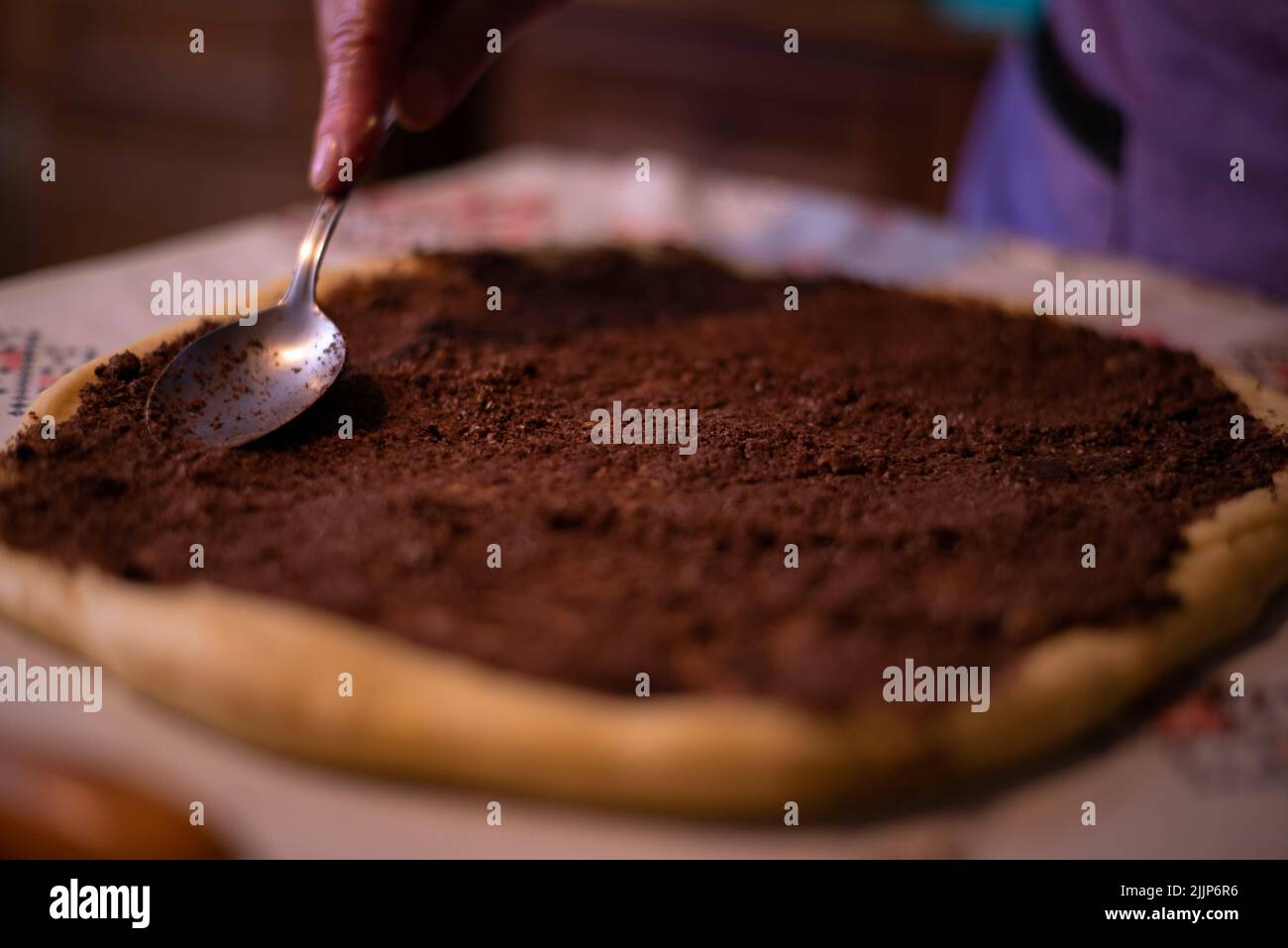 A housewife adding filling to the dough Stock Photo - Alamy