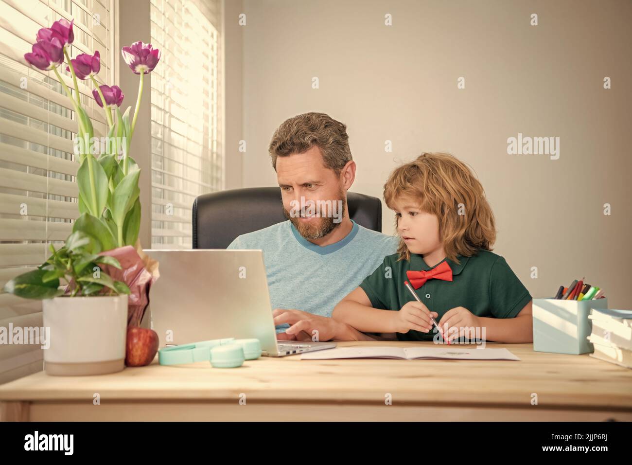 mature man teacher or dad helping kid son with school homework on ...
