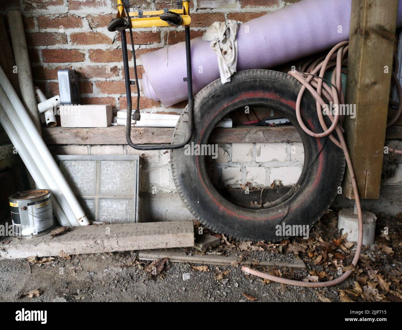 An old wheel and other constructing equipments in a messy area Stock ...