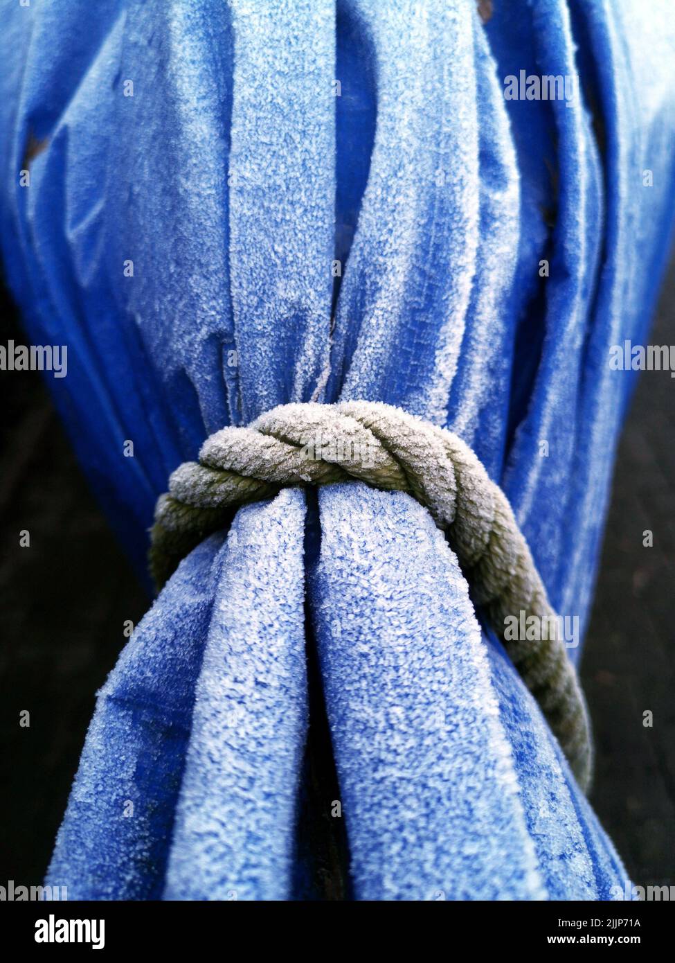 A closeup of a rope tying a blue curtain Stock Photo - Alamy
