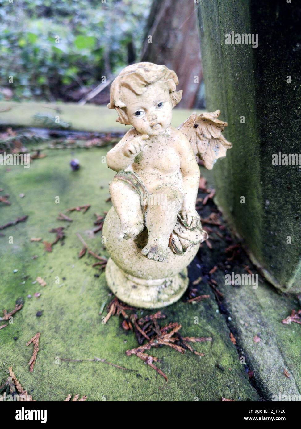 An old angel figure in a messy park Stock Photo - Alamy