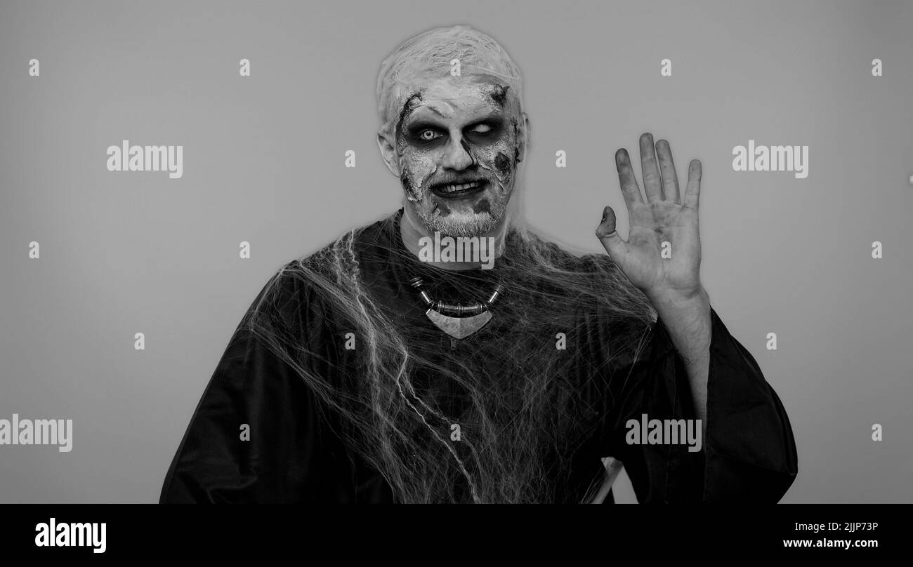 Creepy man with bloody scars face, Halloween zombie make-up. Scary ...