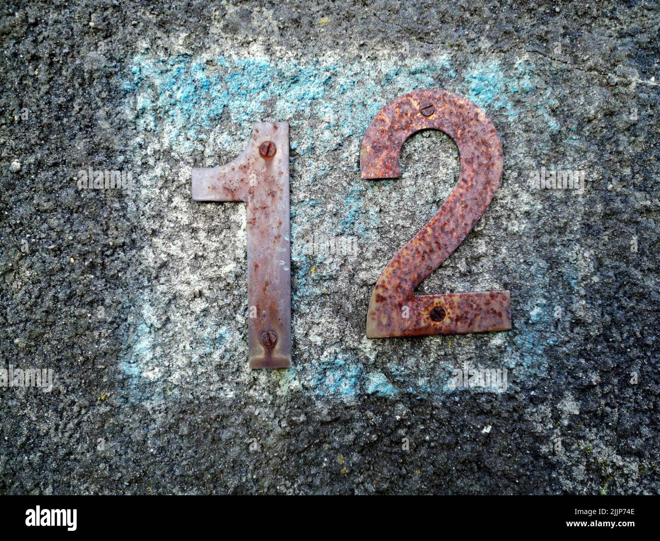 A metallic number twelve attached to the ground Stock Photo - Alamy