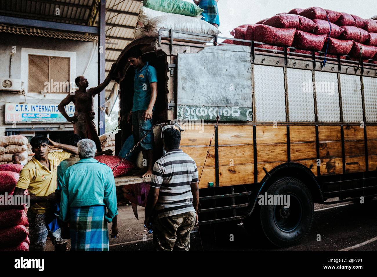 A the truck with the cargo arrived at the warehouse workers unload the ...