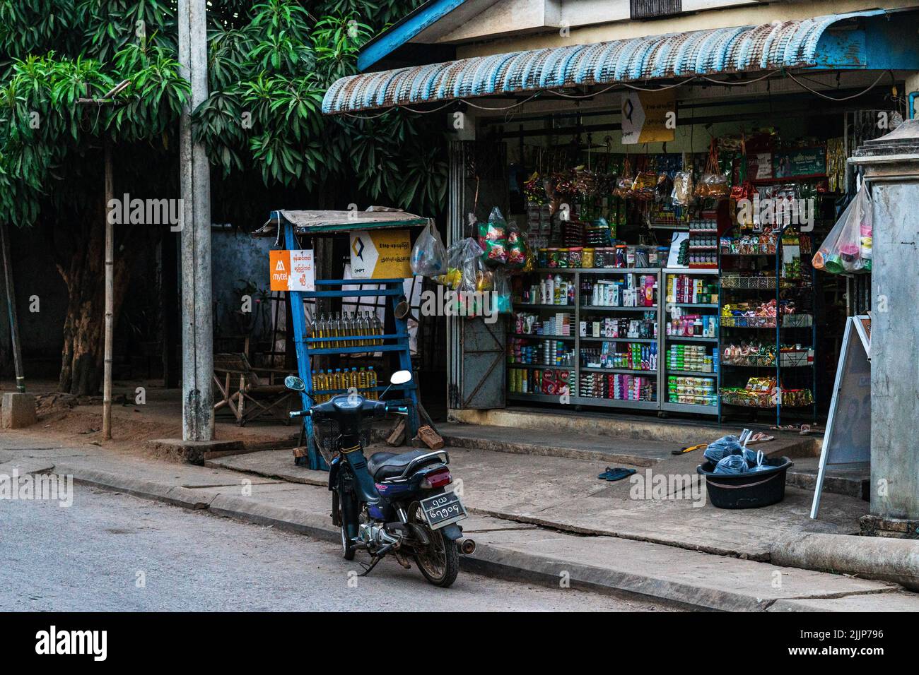 A view of an Outside a general store with a moped parked in Hpa-An ...