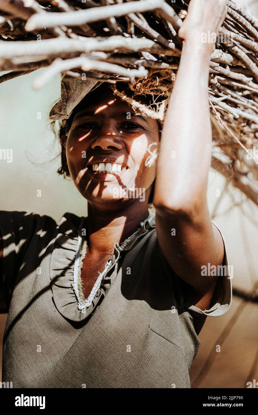A a woman carrying firewood on her head Stock Photo - Alamy