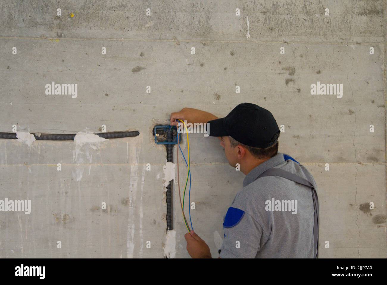 Image of a handyman electrician passing an electric probe through a ...