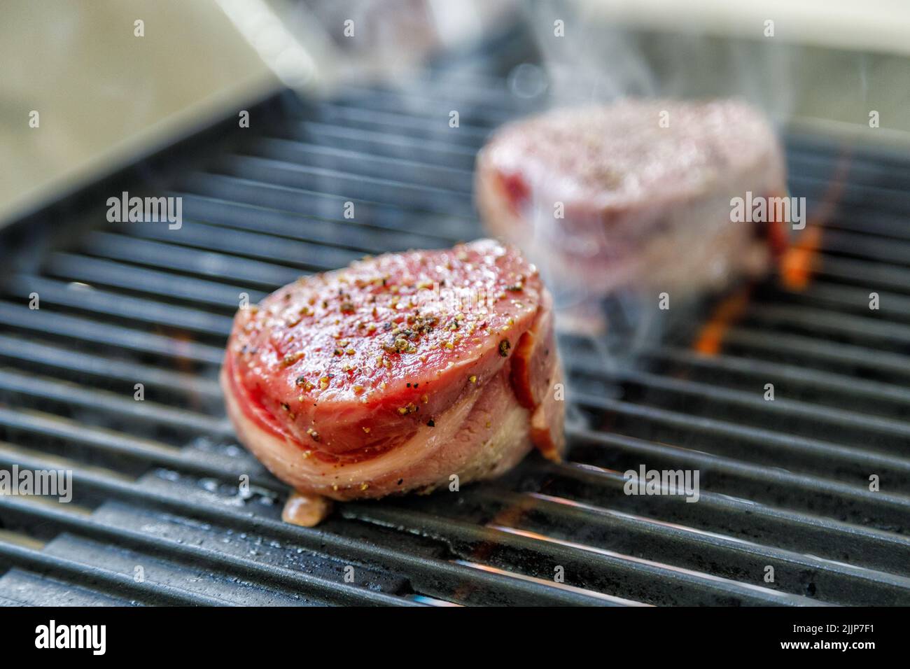 Bacon wrapped filet mignon steak on outdoor camping propane grill Stock ...
