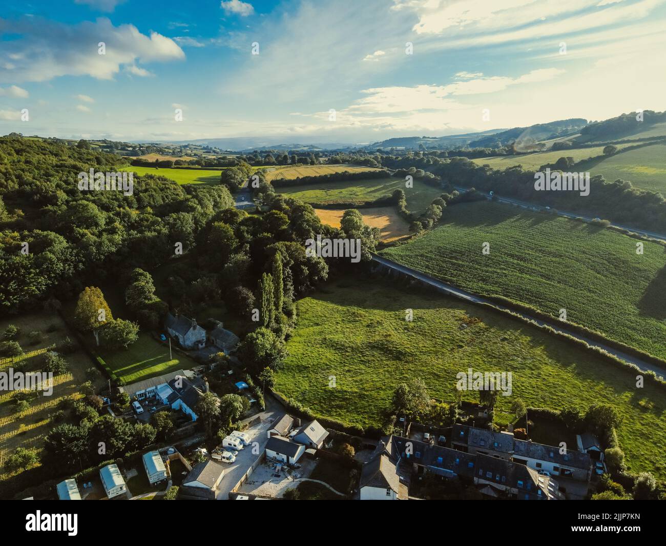 An aerial shot of beautiful landscape surrounded by houses and greenery ...