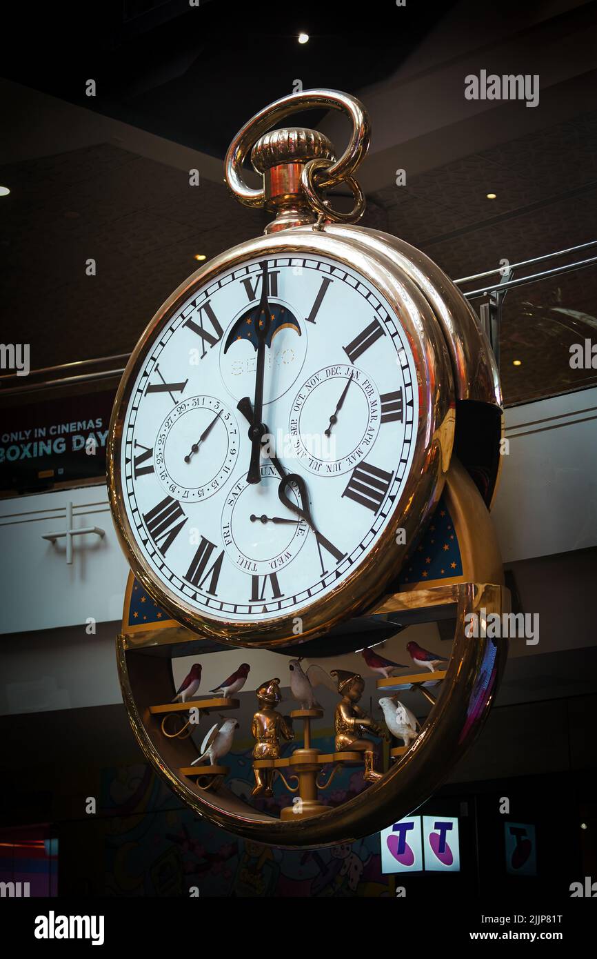 A large clock decorating the interior of a mall in the Melbourne CBD ...