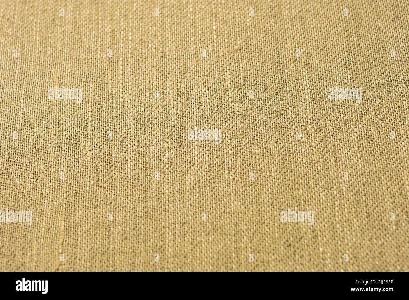 A detailed closeup of an old, brown linen cloth for creative background ...