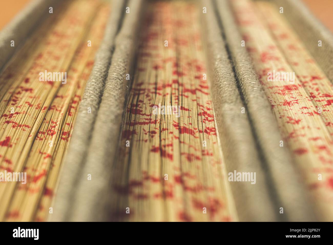 A top view of splashes of red paints on old books side by side Stock ...